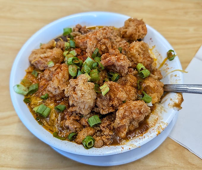 Crispy fried chicken nuggets swimming in savory sauce – proof that sometimes the most unassuming dishes deliver the most profound flavor revelations.