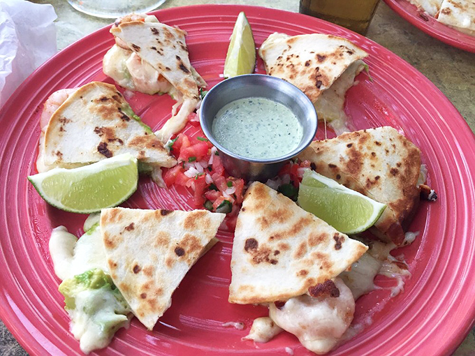 Quesadillas arranged like a delicious clock face. The lime wedges serve as both garnish and that crucial citrus zing that makes everything sing.
