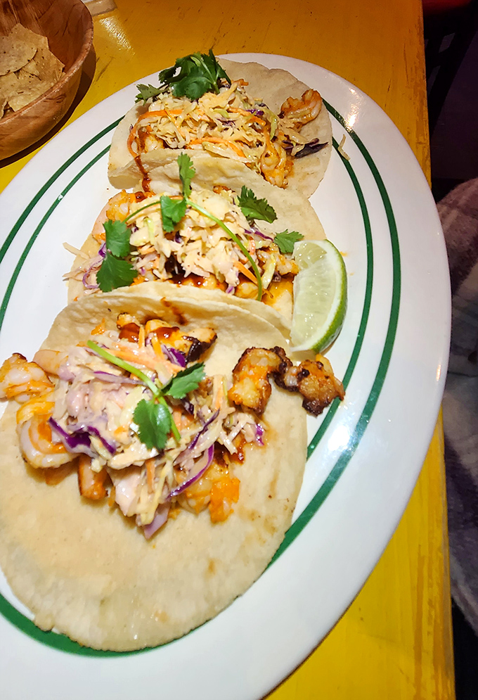 Behold the shrimp tacos that launched a thousand road trips – perfectly grilled crustaceans in tortilla heaven.