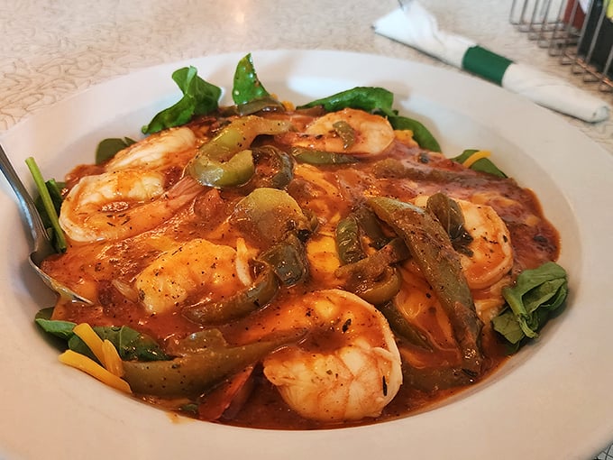 These shrimp aren't just hanging out in the grits—they're throwing a party with roasted peppers, and everyone's invited to this Southern soiree.