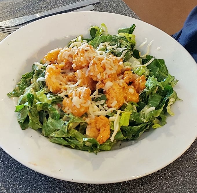 Crispy golden shrimp perched atop fresh greens—a salad that makes you forget you're eating something healthy. Virtue never tasted so indulgent. 