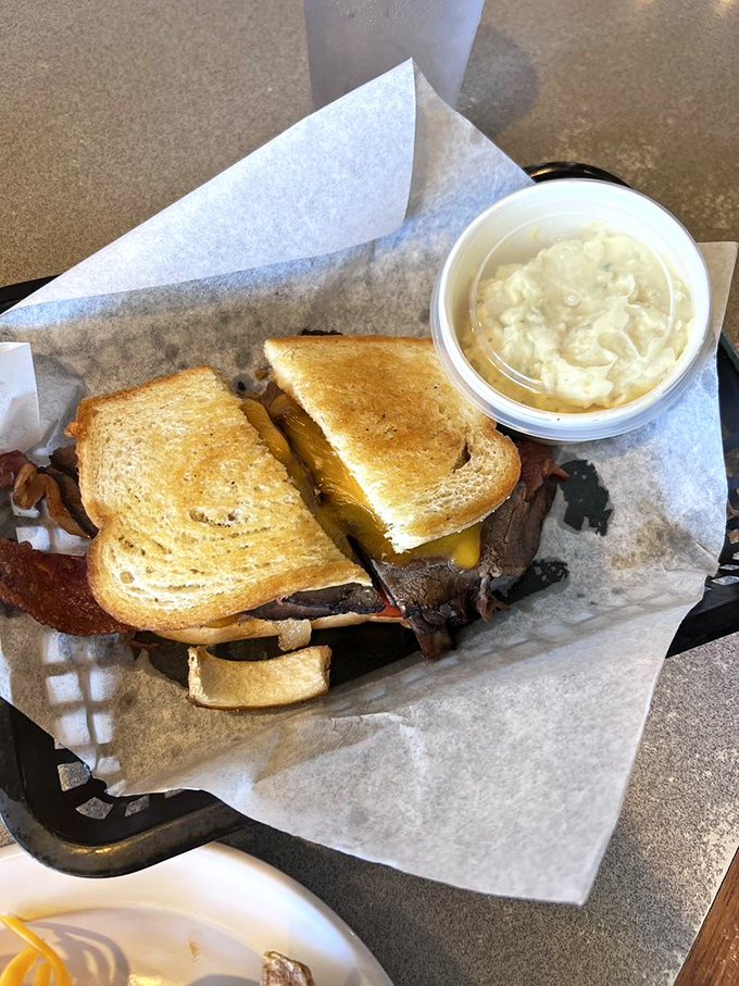The Sierra Sandwich arrives as a towering testament to hearty appetites, loaded with bacon and melted cheese perfection.