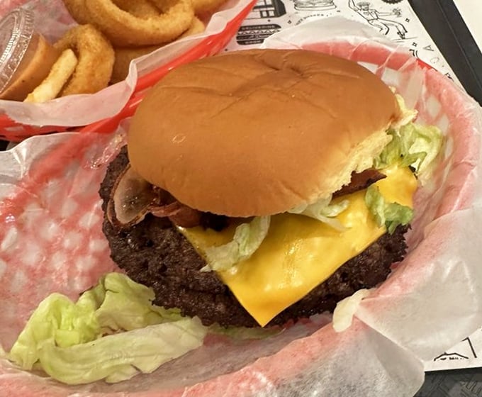 Behold the perfect smash burger—crispy-edged patty, melty American cheese, and fresh toppings nestled in a bun that knows its supporting role.