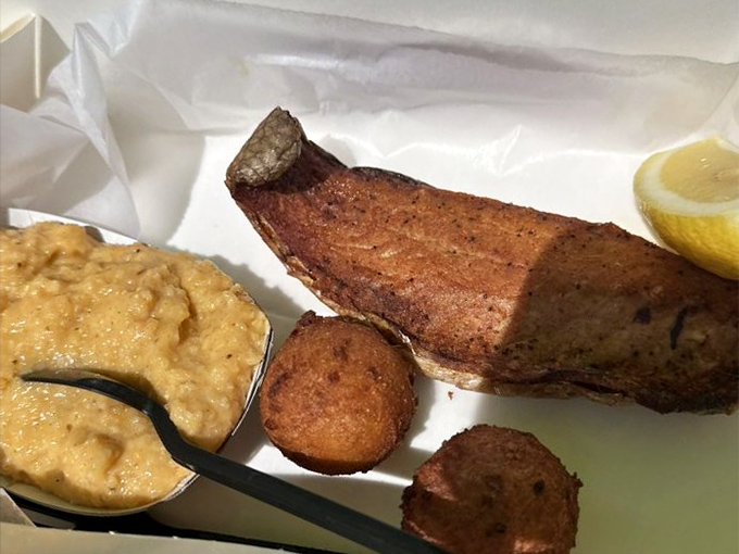 Smoked mullet with cheese grits and hush puppies—the holy trinity of Old Florida cuisine. Comfort food with maritime credentials.