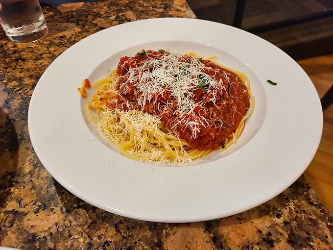 Spaghetti that would make nonna weep with joy—a simple dish elevated to art form with bright tomato sauce and a snowfall of cheese.