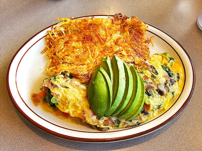 This omelet doesn't just have spinach—it embraces it. The avocado fan is nature's way of saying "California loves you."