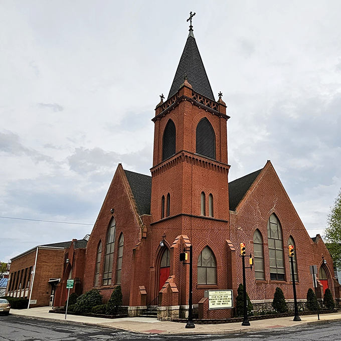 The brick church stands as a testament to community values, its steeple reaching skyward like the town's affordable housing market – a blessing indeed.