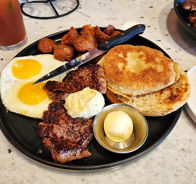 The breakfast trinity: perfectly sunny eggs, crispy potatoes, and a steak that makes you question why you ever settled for cereal.