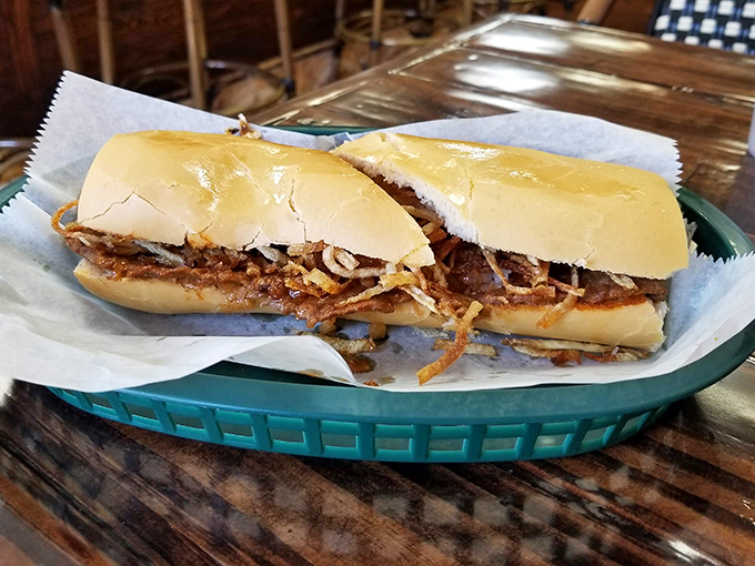 The frita in its natural habitat – crispy potato strings peeking out from seasoned meat on a Cuban roll. Poetry between bread.