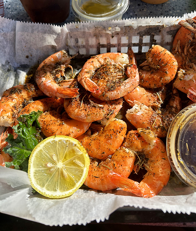 These aren't just shrimp—they're plump, perfectly seasoned treasures from the deep, waiting for their lemon-squeezing baptism before disappearing faster than your vacation days.