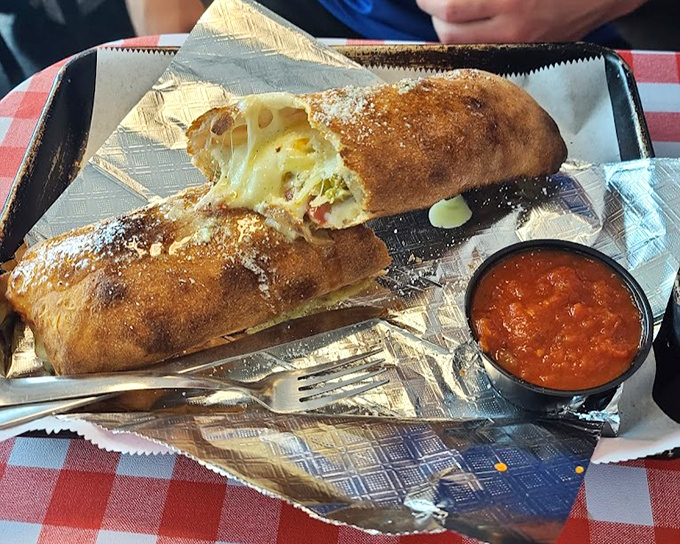 The stromboli here doesn't just stretch when you pull it apart – it performs an entire cheese ballet that deserves its own standing ovation. 