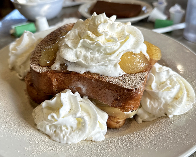 Stuffed French toast that makes ordinary breakfast feel like amateur hour. Those clouds of whipped cream aren't just garnish—they're essential supporting characters.