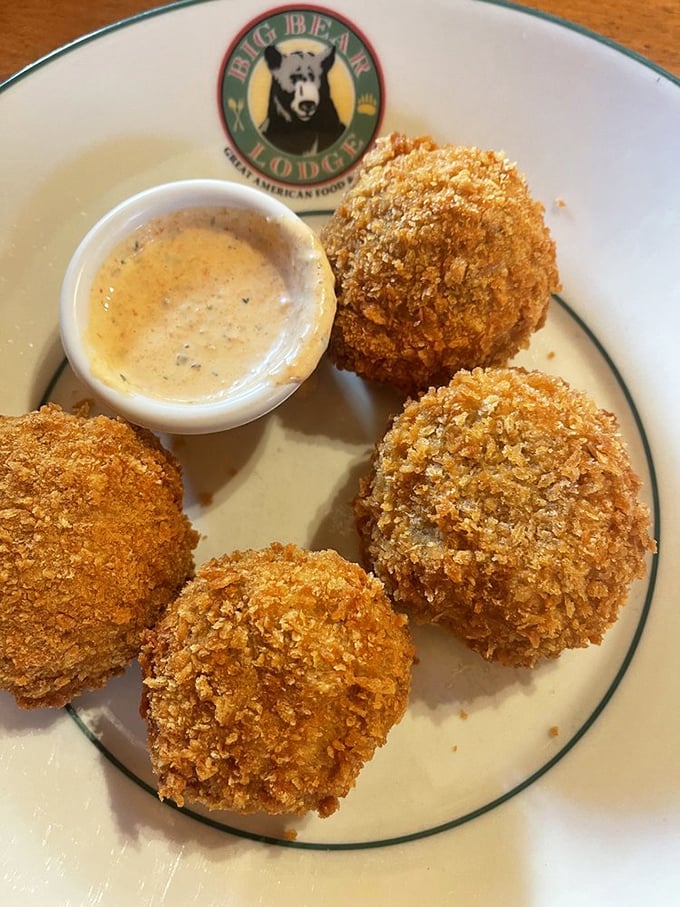 Golden-brown stuffed mushrooms that crunch then yield, revealing a savory interior that makes sharing these little treasures nearly impossible.