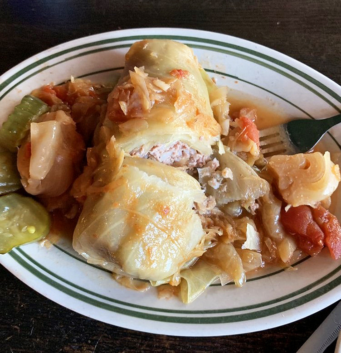 Grandma's secret recipe revealed: tender cabbage leaves embracing a savory mixture of beef, pork and rice, swimming in a tomato sauce that tastes like someone's childhood.