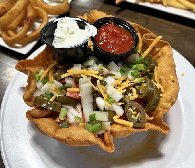 Taco salad that breaks free from its tortilla prison. This colorful rebellion of fresh ingredients, cheese, and jalapeños is ready for your fork's freedom march.