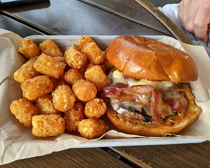 This burger comes with reinforcements – golden tater tots so perfectly crisp they make French fries nervous about their job security.
