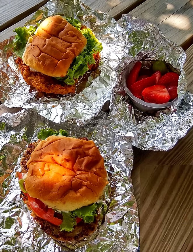 Behold the famous tenderloin sandwich in its natural habitat—a bun comically overwhelmed by golden-fried pork. The "where's the bread?" phenomenon is pure Indiana poetry.