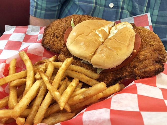 This isn't just a tenderloin sandwich; it's edible architecture—a crispy-coated masterpiece that laughs in the face of your diet plans and wins every time.