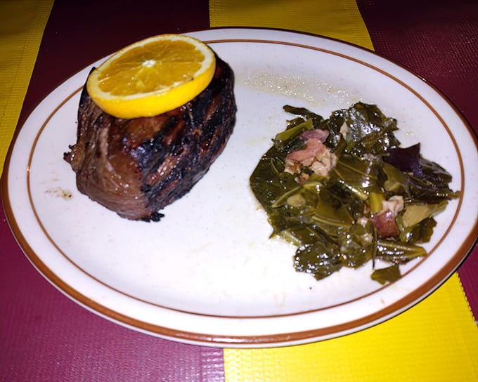 This teriyaki sirloin topped with a bright citrus slice sits alongside collard greens cooked Southern-style—proof that flavor trumps fanciness every time.