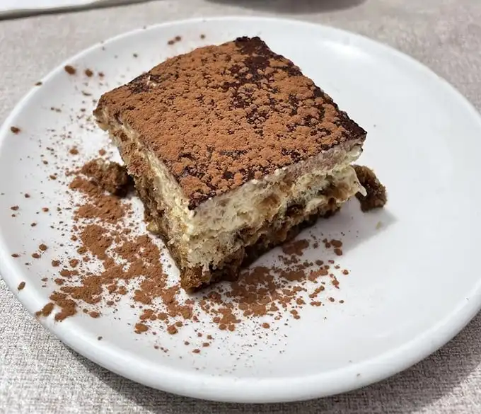 This tiramisu doesn't just satisfy a sweet tooth—it tells tales of Italian grandmothers and their closely guarded secrets. Coffee-soaked bliss.