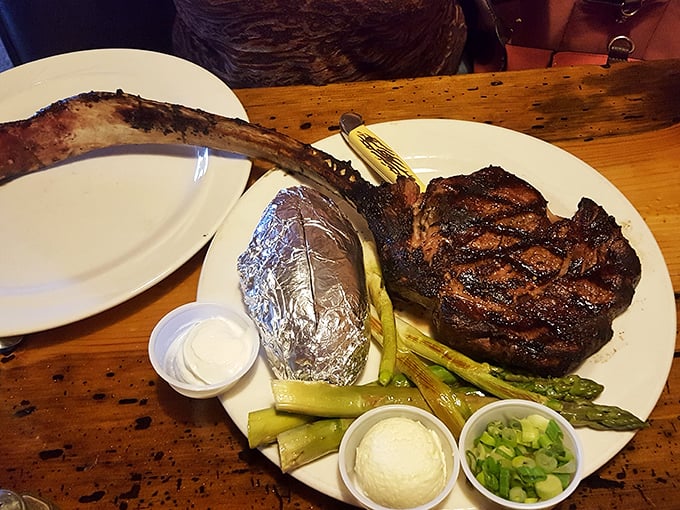 This isn't just a steak, it's a prehistoric declaration of carnivorous intent – complete with asparagus soldiers standing guard over buttery mashed potatoes.