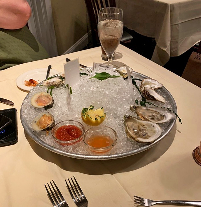 The seafood tower arrives like Neptune's personal offering—briny oysters nestled on ice, waiting for just a squeeze of lemon.