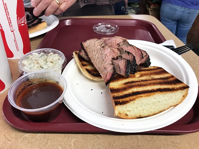 The star of the show: perfectly pink tri-tip on grilled bread, accompanied by coleslaw and sauce – a California dream that fits in two hands.