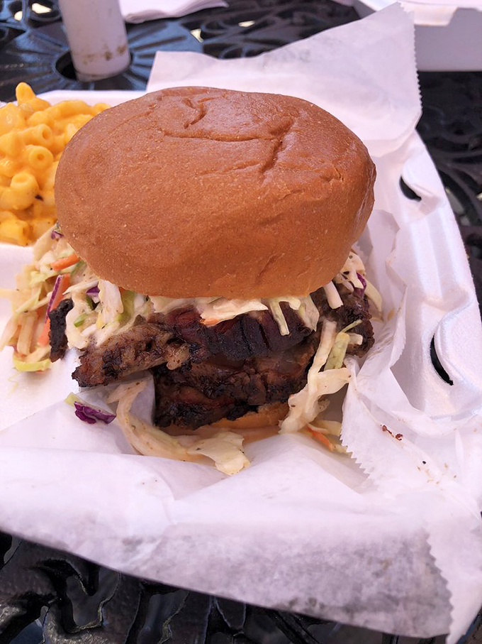 This isn't just a sandwich; it's an architectural marvel of smoke-kissed meat, crisp slaw, and a bun that knows its supporting role perfectly. 