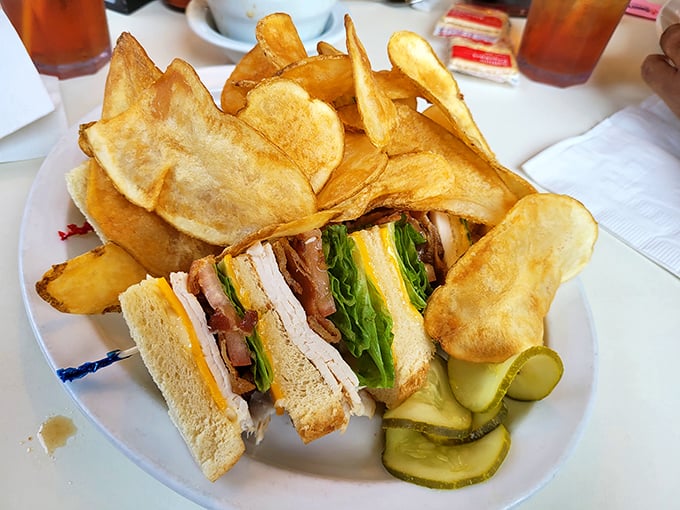The club sandwich—architecture you can eat. Those homemade chips aren't just sides, they're supporting characters in this lunchtime drama.