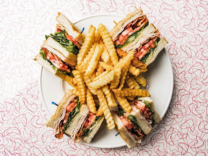 This isn't just a sandwich—it's architecture. The Turkey Club stands tall like Delaware's own edible skyscraper, complete with bacon buttresses.