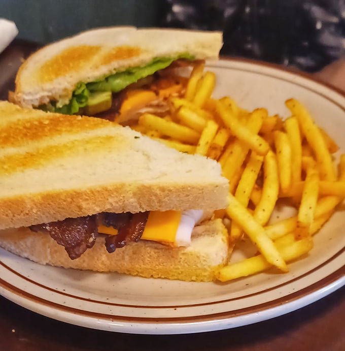 A sandwich so perfectly constructed it deserves its own architectural award—the Turkey Club at Sweet P's doesn't just satisfy hunger, it conquers it.