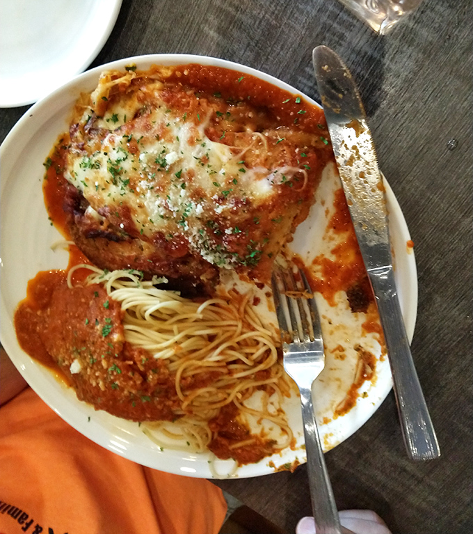 Half-eaten veal parmigiana with spaghetti—the universal sign that something was too good to wait for a photo before diving in.