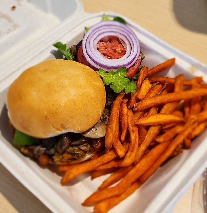 This isn't just a veggie burger—it's proof that plant-based can be indulgent. Those sweet potato fries are the supporting actors stealing the show.