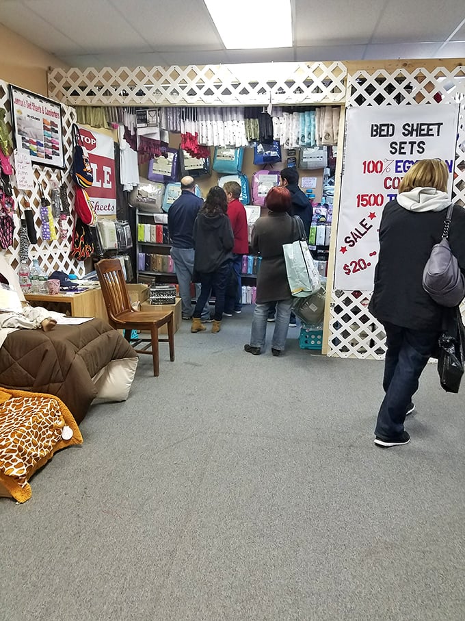 The indoor section offers climate-controlled treasure hunting—where serious shoppers examine bed linens with the focus of archaeologists at a dig site.