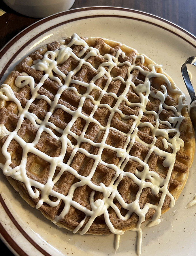 Waffles wearing frosting like a tailored suit. The grid pattern isn't just for show—it's strategic syrup-catching engineering at its finest.