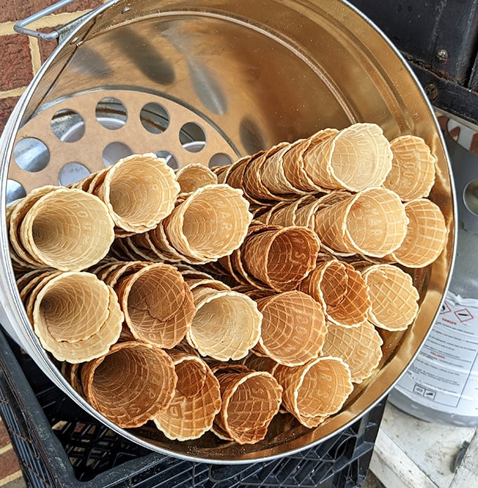 These golden waffle cones aren't just containers; they're crispy, warm works of art waiting to cradle scoops of creamy nostalgia.