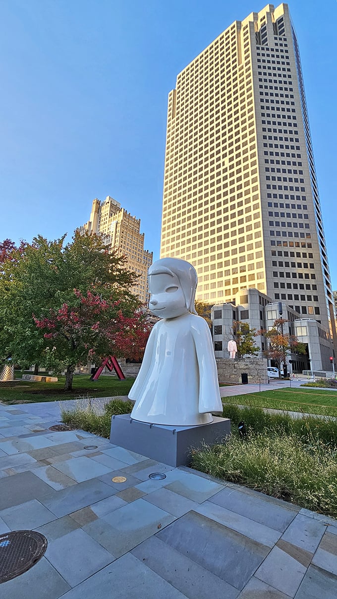 "White Ghost" contemplates the urban landscape with serene detachment. This alabaster figure brings a zen-like calm to the bustling downtown environment.