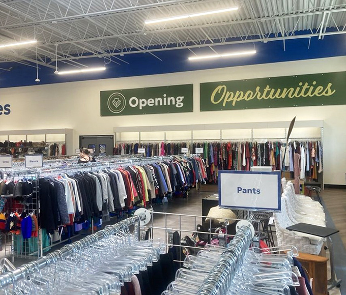 The clothing section stretches toward the horizon like a textile ocean. "Opening Opportunities" isn't just a sign—it's the store's entire philosophy.
