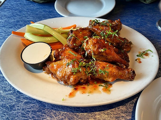 These wings aren't just crispy, they're life-affirming—glistening with sauce and garnished with fresh herbs that elevate them from bar food to culinary statement.