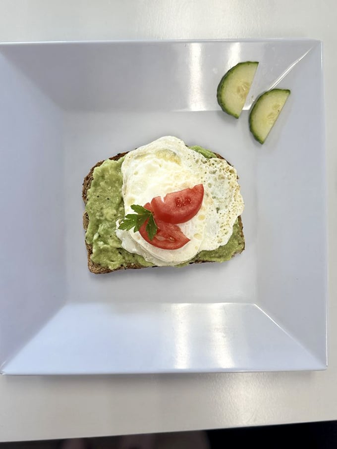 Avocado toast gets the German precision treatment—a perfectly poached egg crowning creamy avocado on hearty bread. Breakfast engineering at its finest!