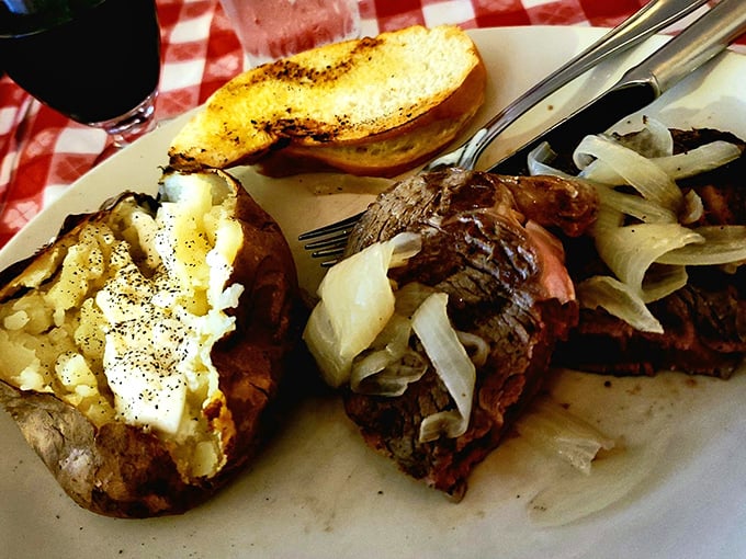 The loaded baked potato isn't just a side dish—it's the Robin to your steak's Batman, a worthy companion to greatness.