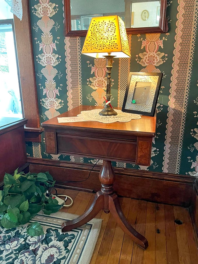 This isn't just a vintage side table—it's a perfectly preserved vignette of how our grandparents lived, complete with hand-punched lampshade.