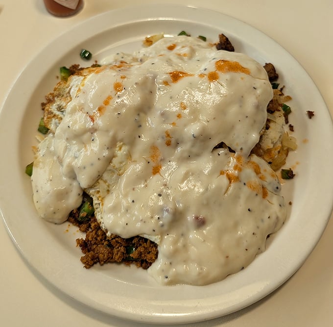 Biscuits and gravy so good they should require a permission slip—a creamy, peppery blanket covering everything in its path with delicious intent.