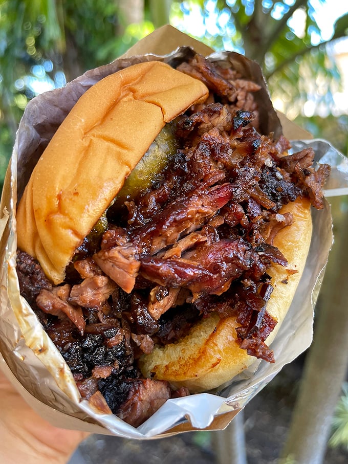 Behold the brisket sandwich in its natural habitat—a soft bun cradling bark-crusted meat that's spent hours communing with smoke. This is what patience tastes like.