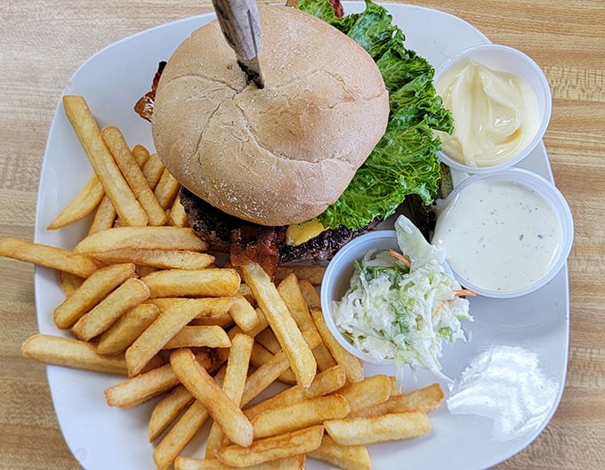 This isn't just a burger—it's architecture. Stacked high with all the fixings and surrounded by a golden battalion of perfectly crisp fries.