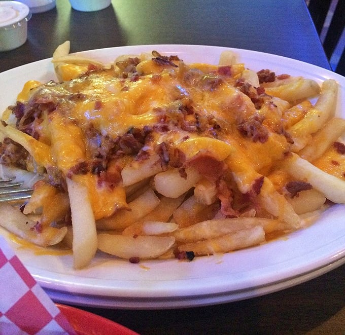 These aren't just cheese fries; they're a commitment to excess done right—crispy potatoes smothered in melted cheese and bacon bits that demand to be shared.