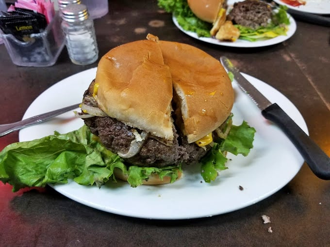This isn't some fancy gastropub creation – it's an honest-to-goodness burger that would make your cardiologist wince and your taste buds sing. 