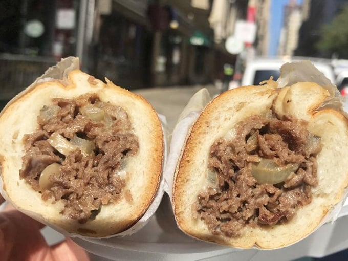 Philadelphia's sandwich culture in cross-section: thinly sliced beef and caramelized onions nestled in a roll that's both cloud and cradle.