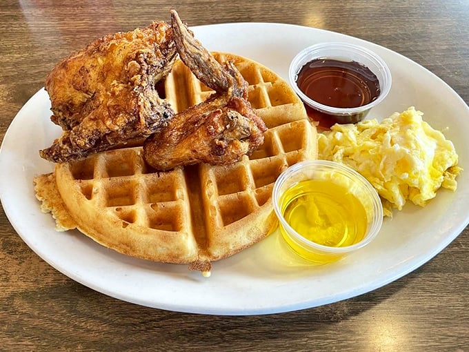 This isn't just chicken and waffles—it's a master class in texture. The crackling exterior of that fried chicken surrendering to juicy tenderness is worth every calorie.