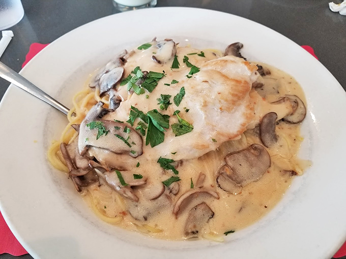 This chicken marsala isn't just dinner—it's a mushroom-studded masterpiece swimming in a sauce worth bottling and taking home.